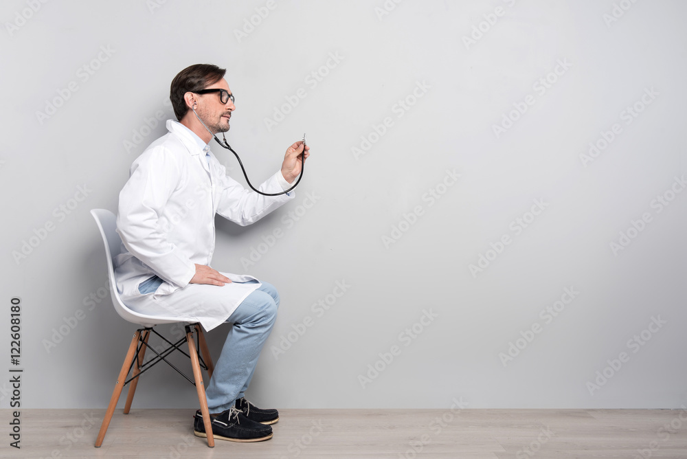 Handsome doctor diagnosing the patient Stock Photo | Adobe Stock