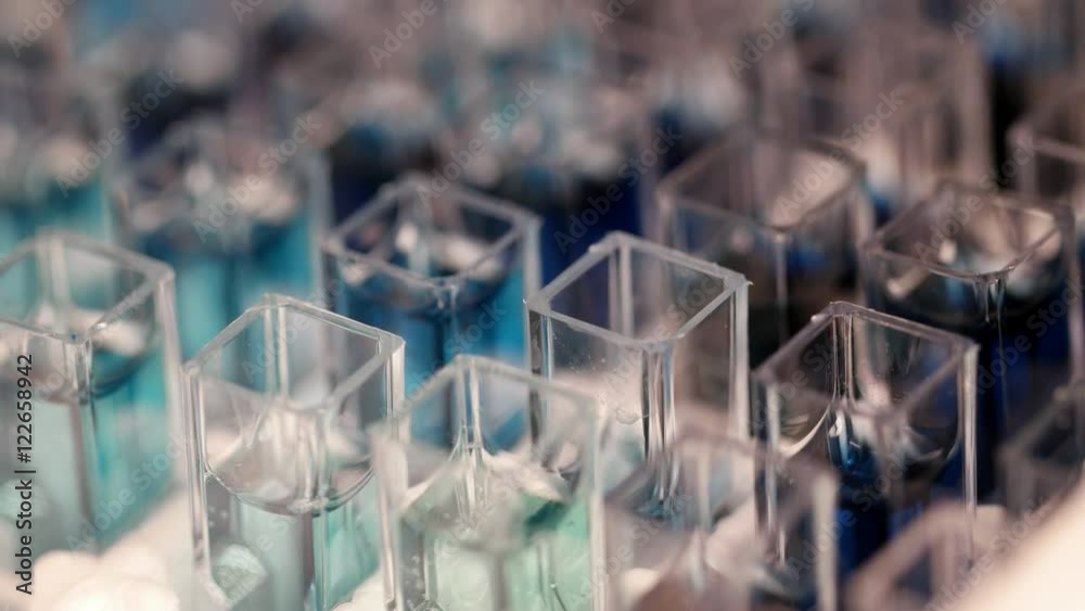 Sample filling in spectrophotometer cuvettes for analysis, close up ...