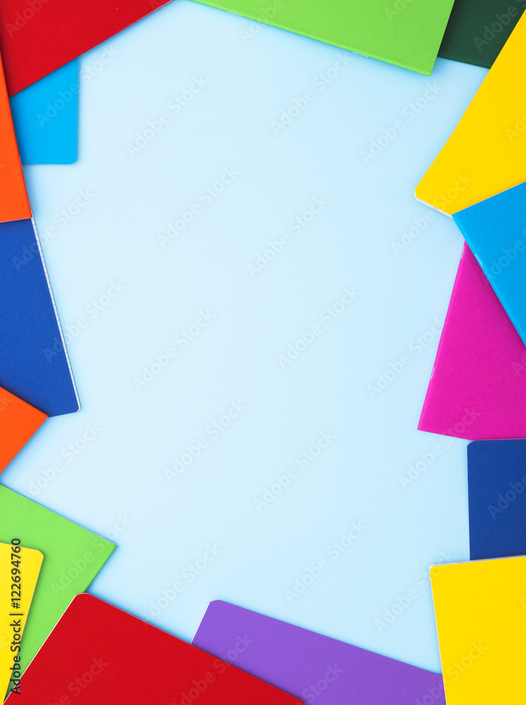 Blue background with blank notebooks. Rainbow colors. Copy space ...