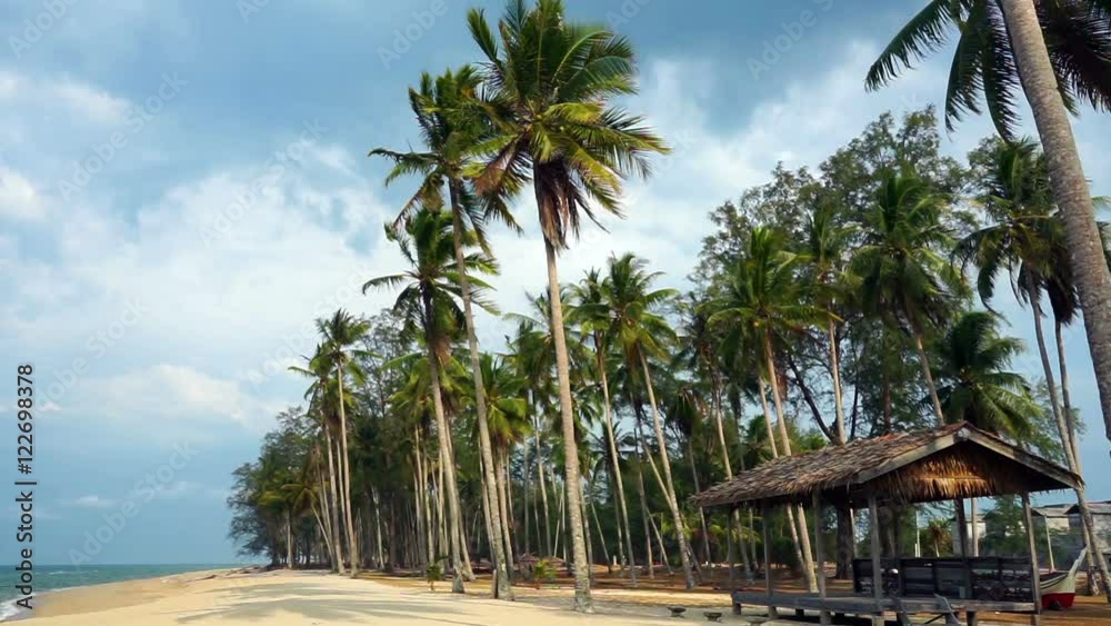 FULL HD coconut trees, cloudy sky and wooden hut with at the beach of ...