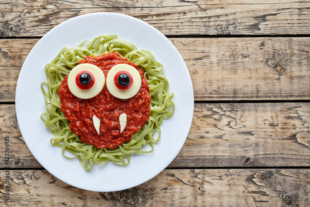 Green spaghetti pasta creative halloween food vampire monster with fake ...