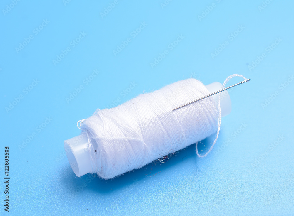 white threads and a needle Stock Photo | Adobe Stock