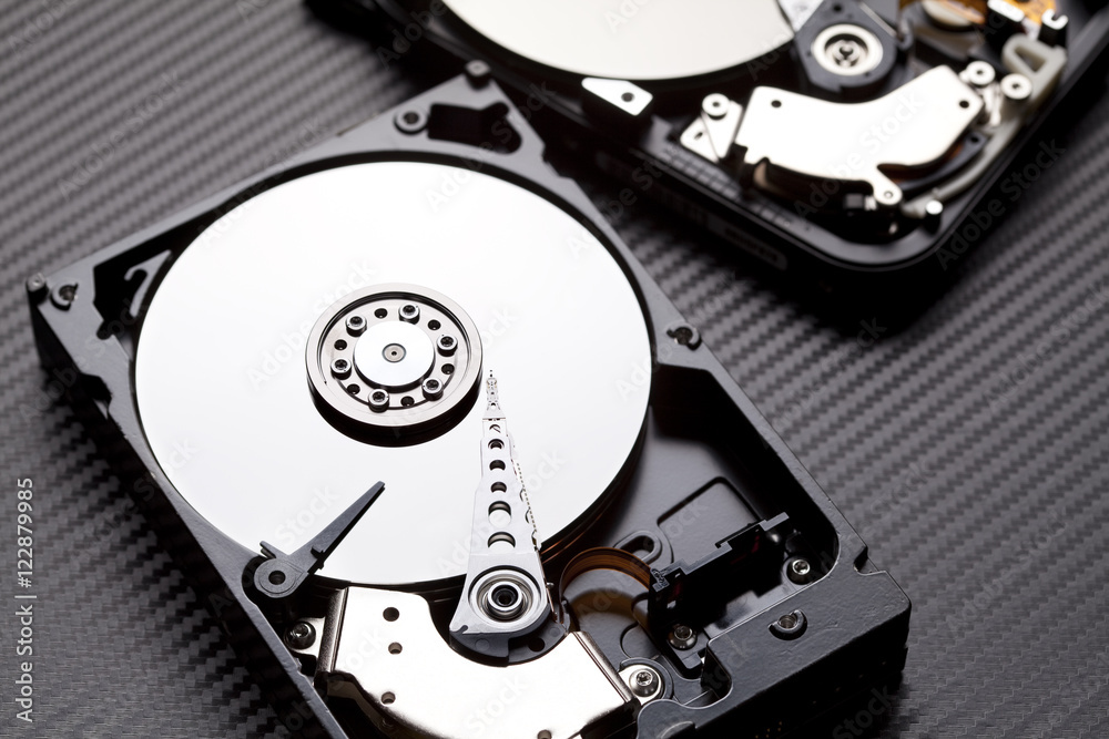 Two hard disk drive on carbon background Stock Photo | Adobe Stock