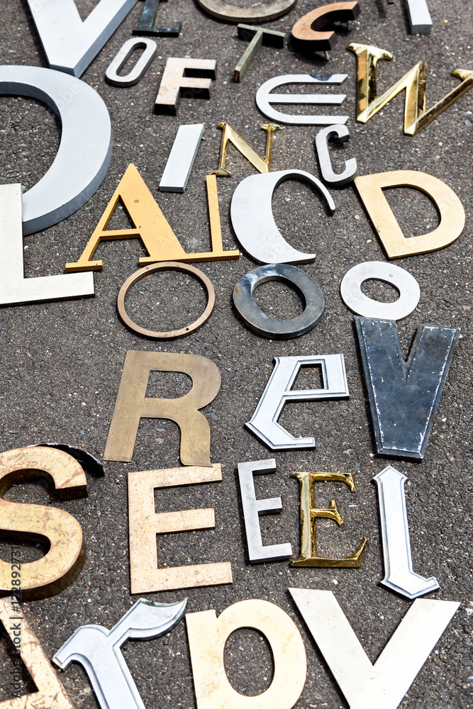 Vintage metal letters in various fonts and sizes, on concrete ...
