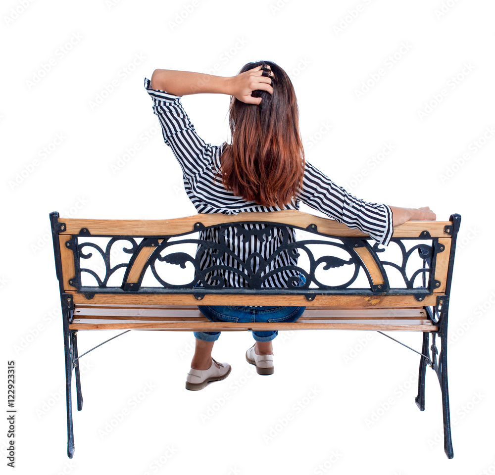 Back view of a woman sitting on a bench. girl watching. Rear view ...
