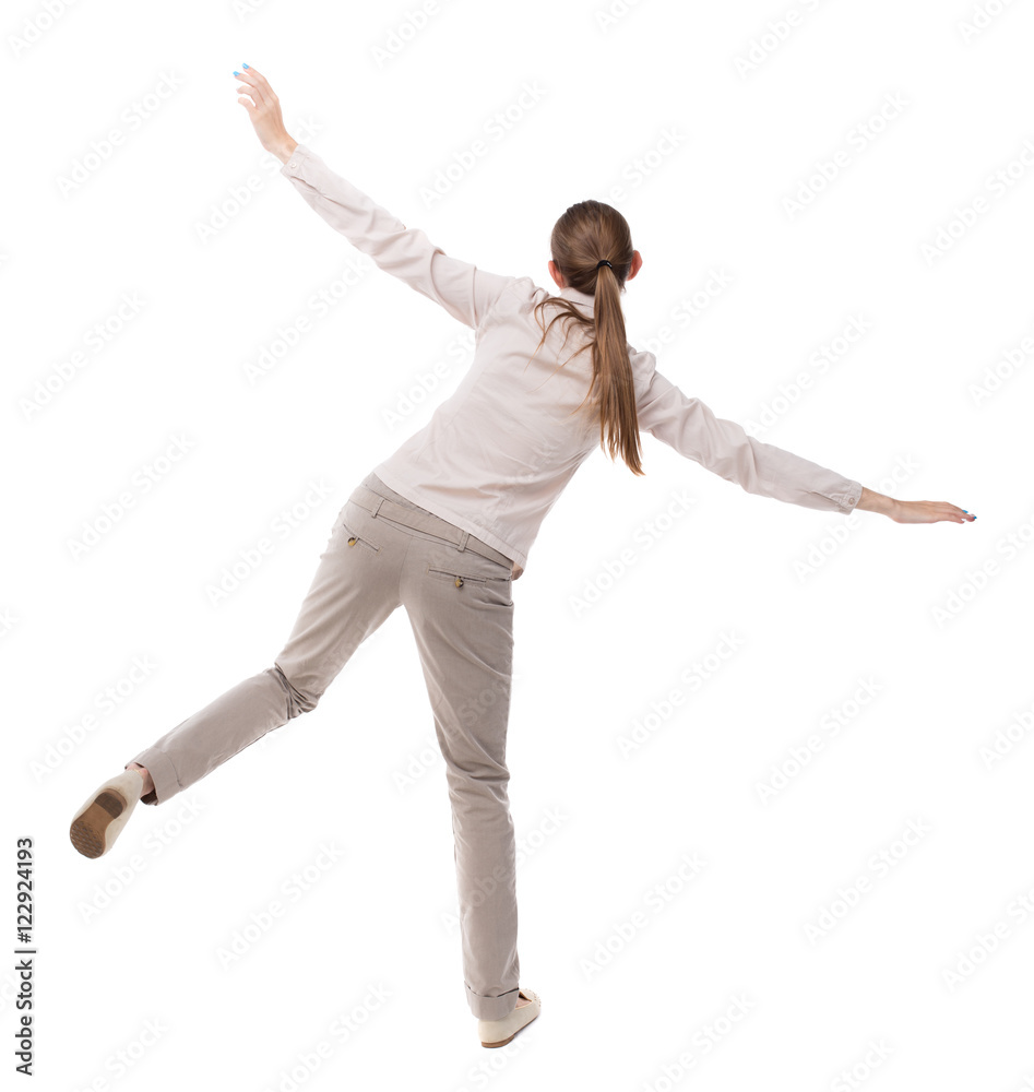 Balancing young woman. or dodge falling woman. Rear view people ...