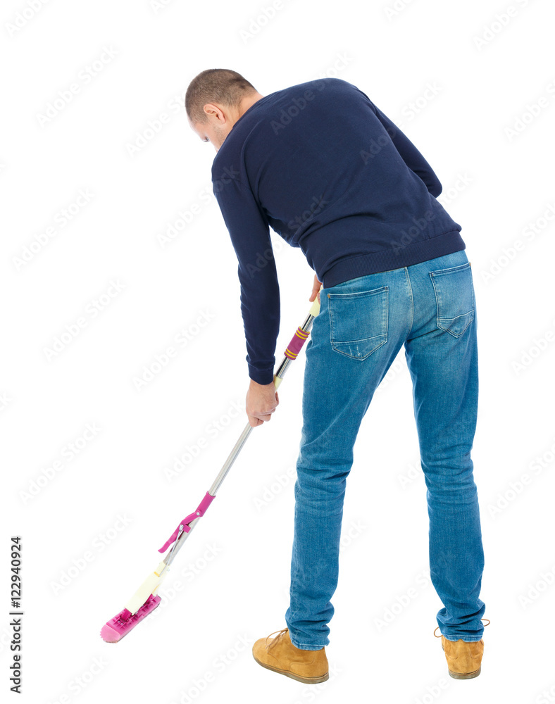Back view of a man washing floor mop. He is busy cleaning. Rear view ...