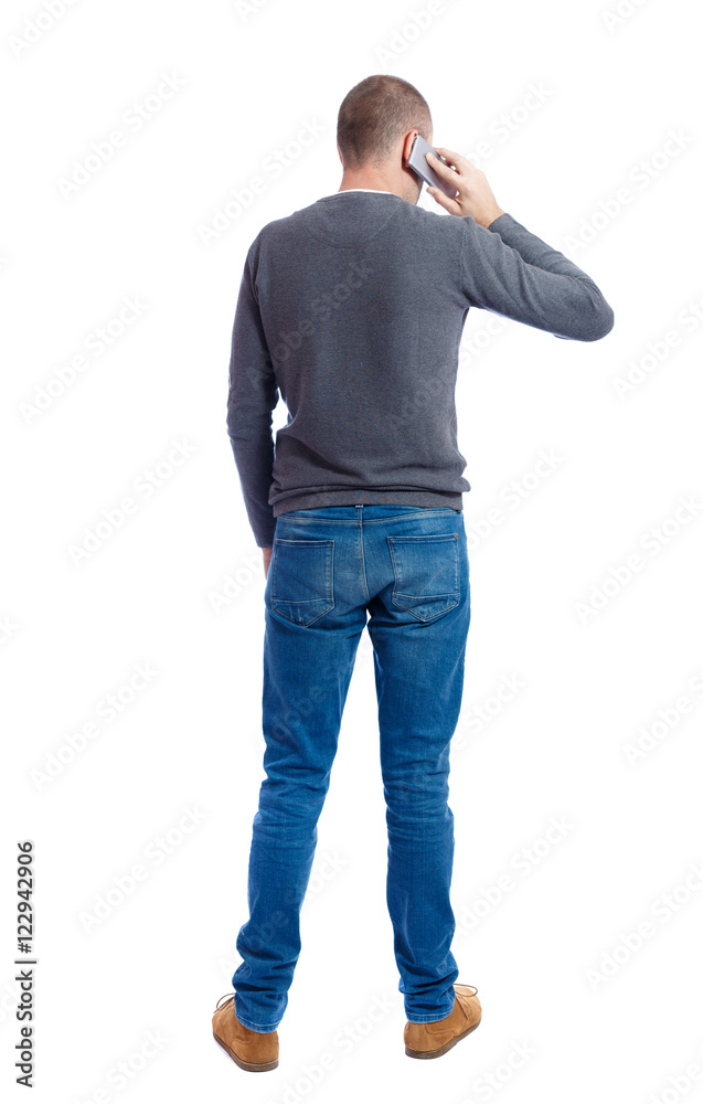Back view of pointing young men talking on cell phone. Young guy ...