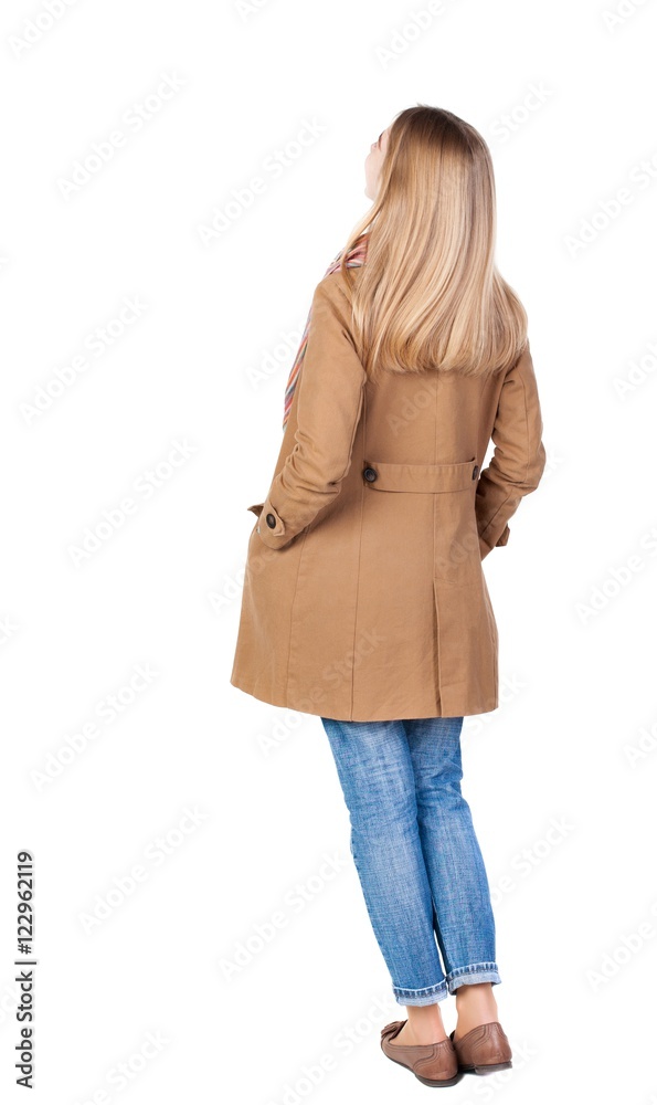 back view of standing young beautiful blonde woman in brown cloak. girl ...