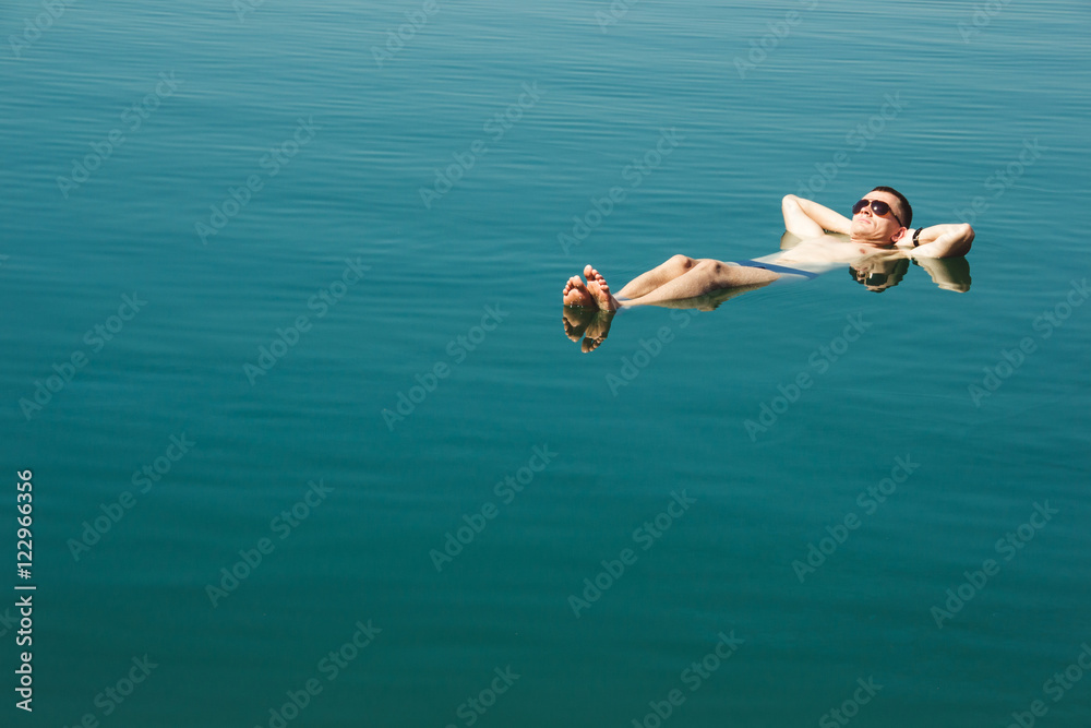 Man floating and relax in water Dead Sea. Tourism recreation, healthy ...