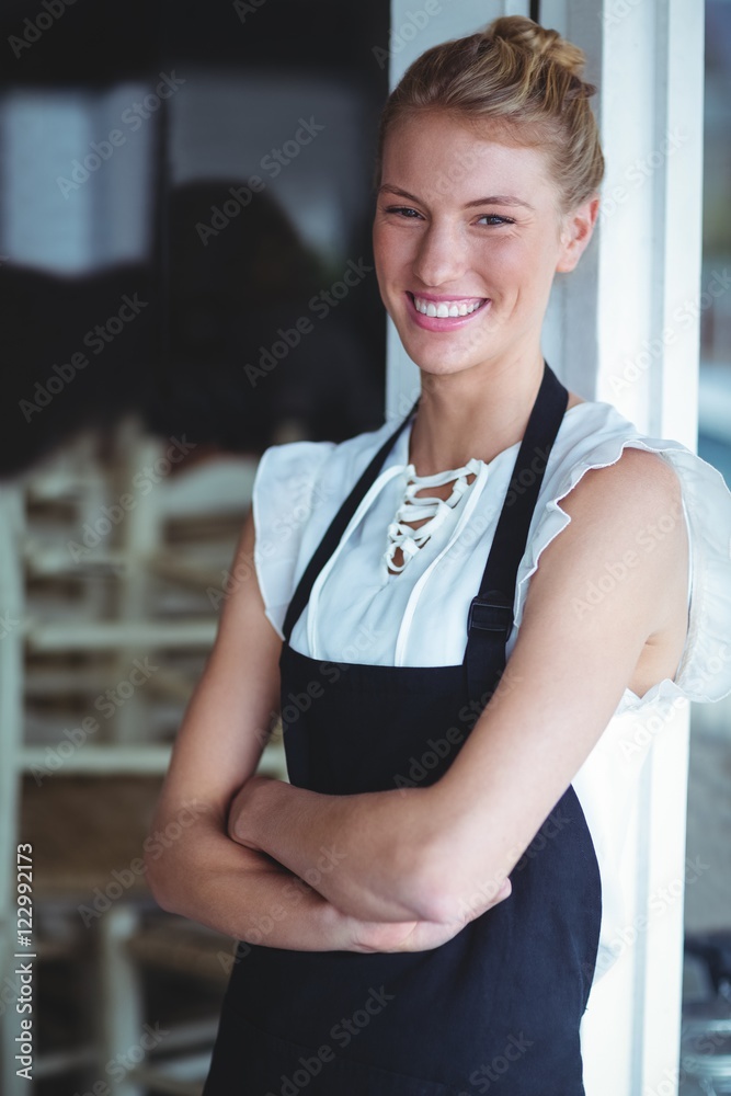 Portrait of smiling waitress standing with arms crossed Stock Photo ...