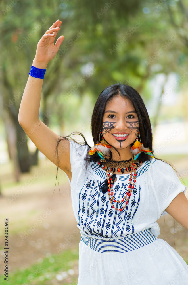 Beautiful Amazonian woman with indigenous facial paint and white ...