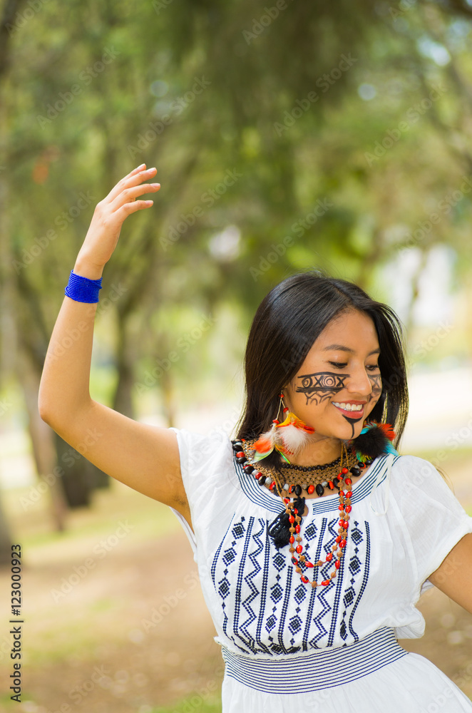 Beautiful Amazonian woman with indigenous facial paint and white ...