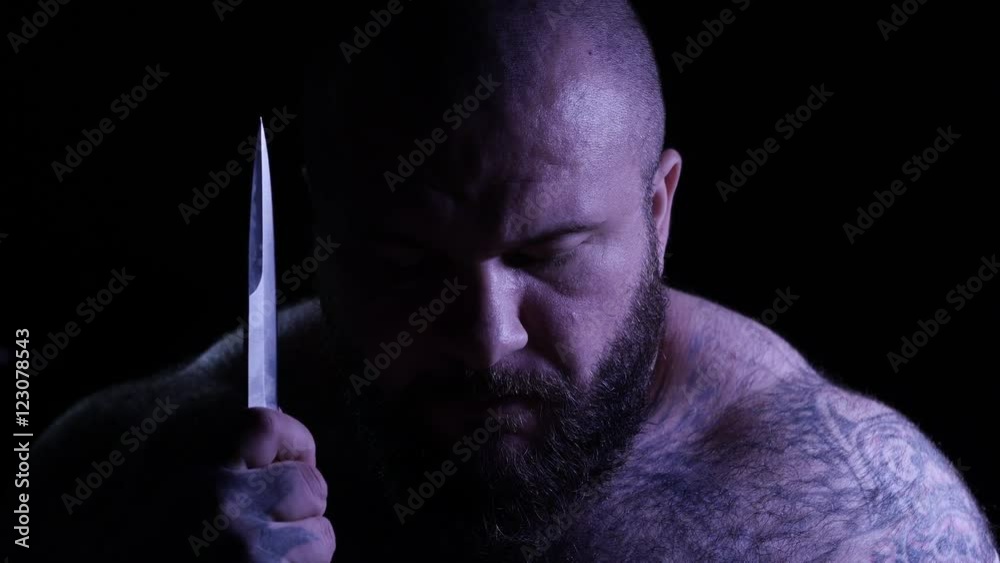 Bald tattoed bearded muscular gangster with a knife. 4K UHD Stock-Video ...