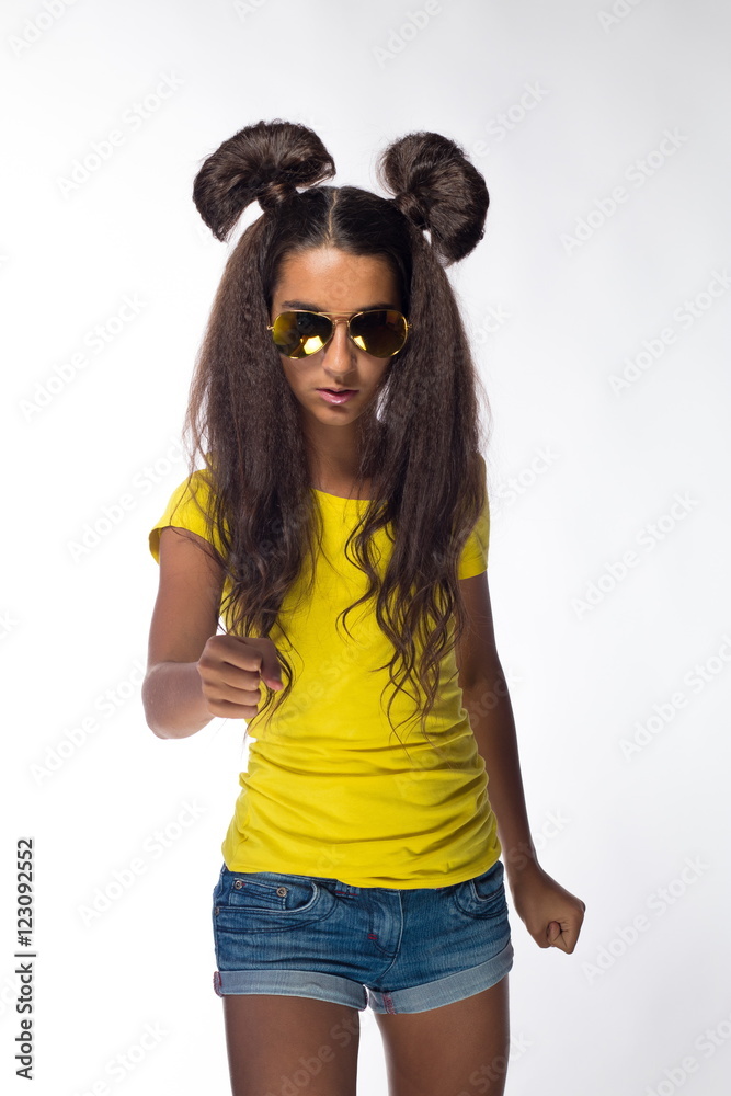 Emotional young brunette girl with long hair in yellow shirt and ...