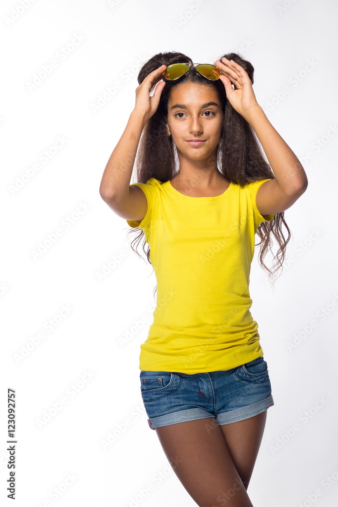 Emotional young brunette girl with long hair in yellow shirt and ...