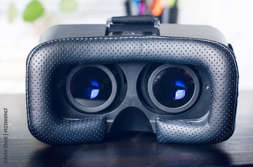 Virtual reality goggles on a table and white background. Technology ...