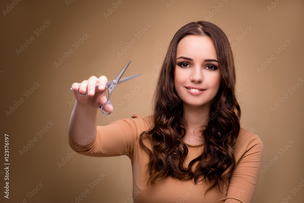 Beautiful woman with scissors cutting her hair Stock-Foto | Adobe Stock