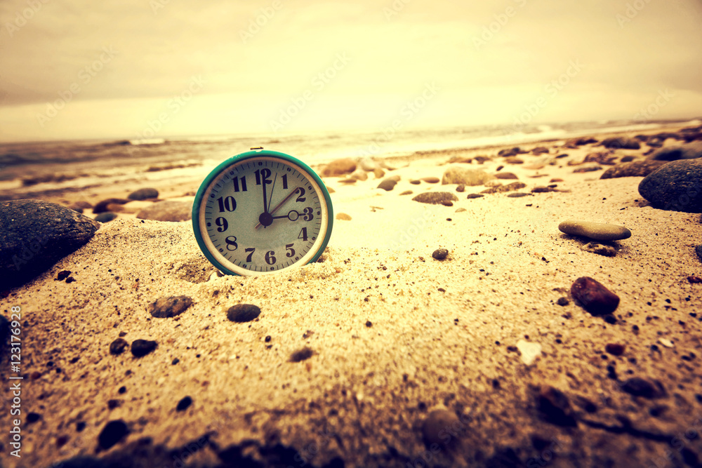 Clock on the beach. Time and business concept. Stock Photo | Adobe Stock