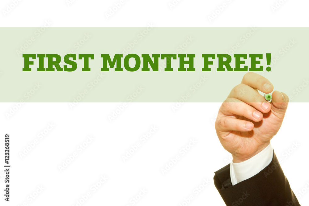 Hand writing "First month free" with a marker on a transparent wipe ...