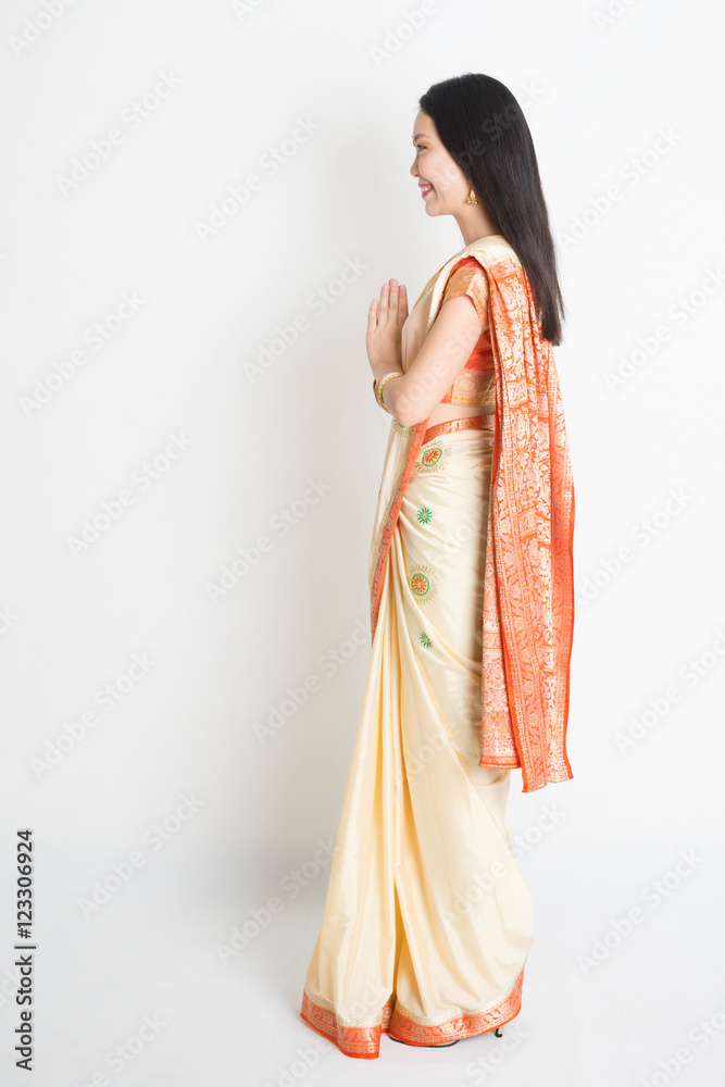 Side view woman in Indian sari dress greeting Stock Photo | Adobe Stock