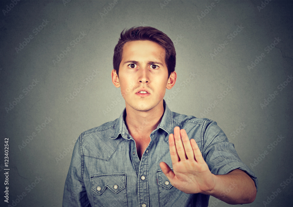 Portrait disgusted angry young man with stop hand gesture Stock Photo ...
