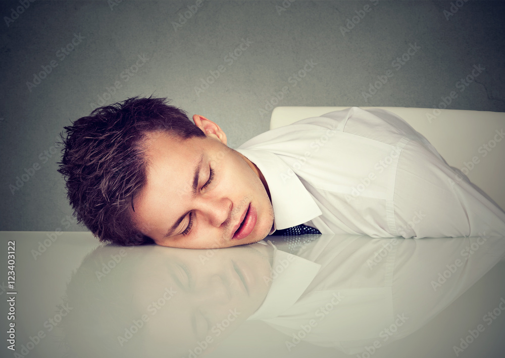 Man sleeping on a desk office table Stock Photo | Adobe Stock