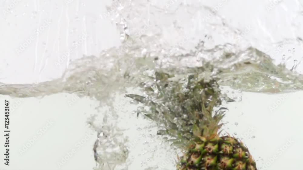 Tropical fruits falling into water on white background slow motion HD ...