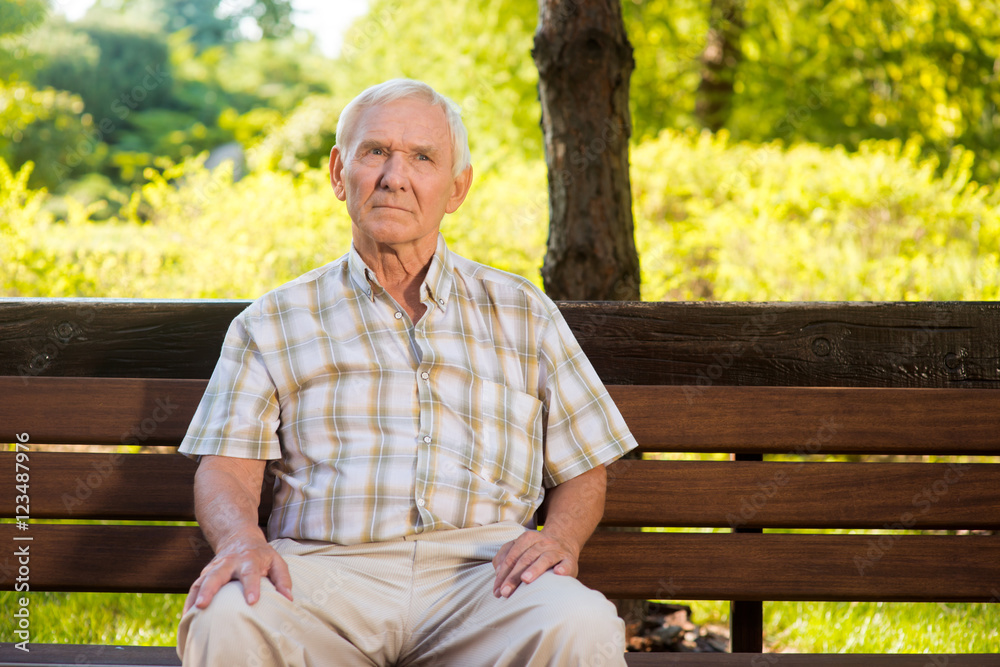 Old man sitting on bench. Elderly guy with thoughtful face. Things used ...