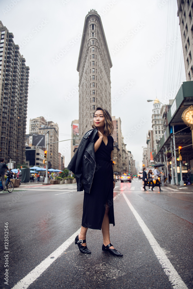 Fashionable asian woman crossing New York City street at Manhattan wear ...
