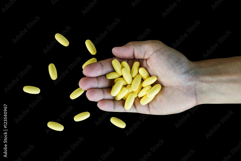 man holding a bunch of drugs in his hand, on a black background. Stock ...