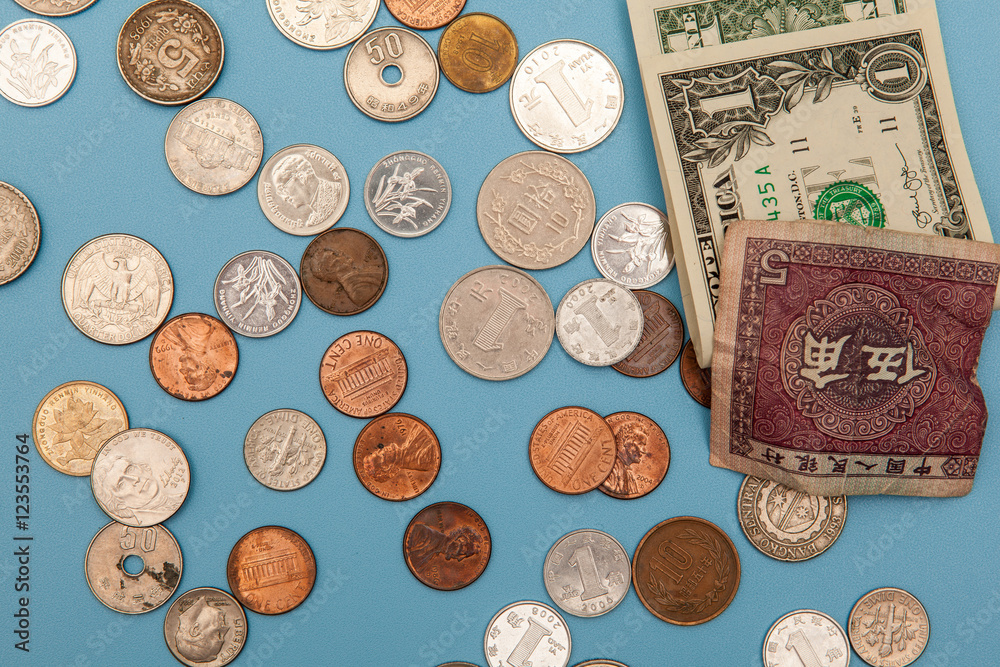 paper money and coins of many country on blue background Stock Photo ...