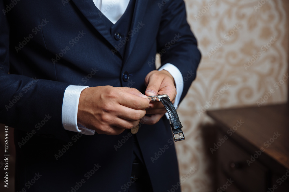 Businessman checking time on his wristwatch. men's hand with a watch ...