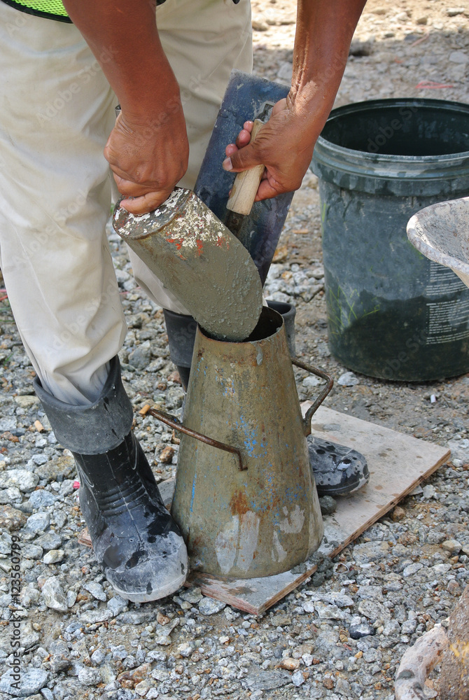 Construction workers doing slump test using equipment at the ...