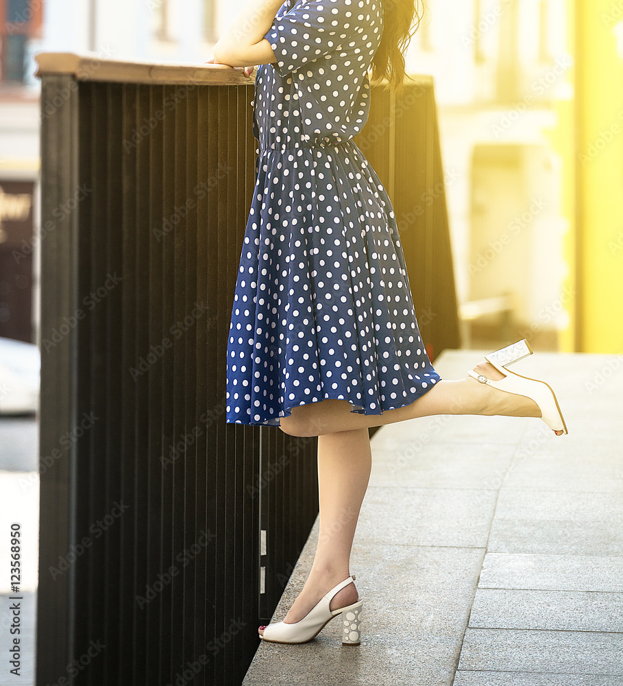 young beautiful woman in a blue sundress posing in the summer near the ...