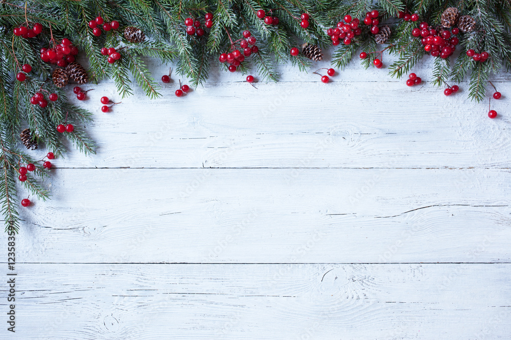 Christmas wooden background with branches of trees, pine cones and red ...