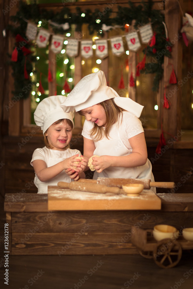 Girls cook with a rolling pin to stretch dough, the concept of c Stock ...