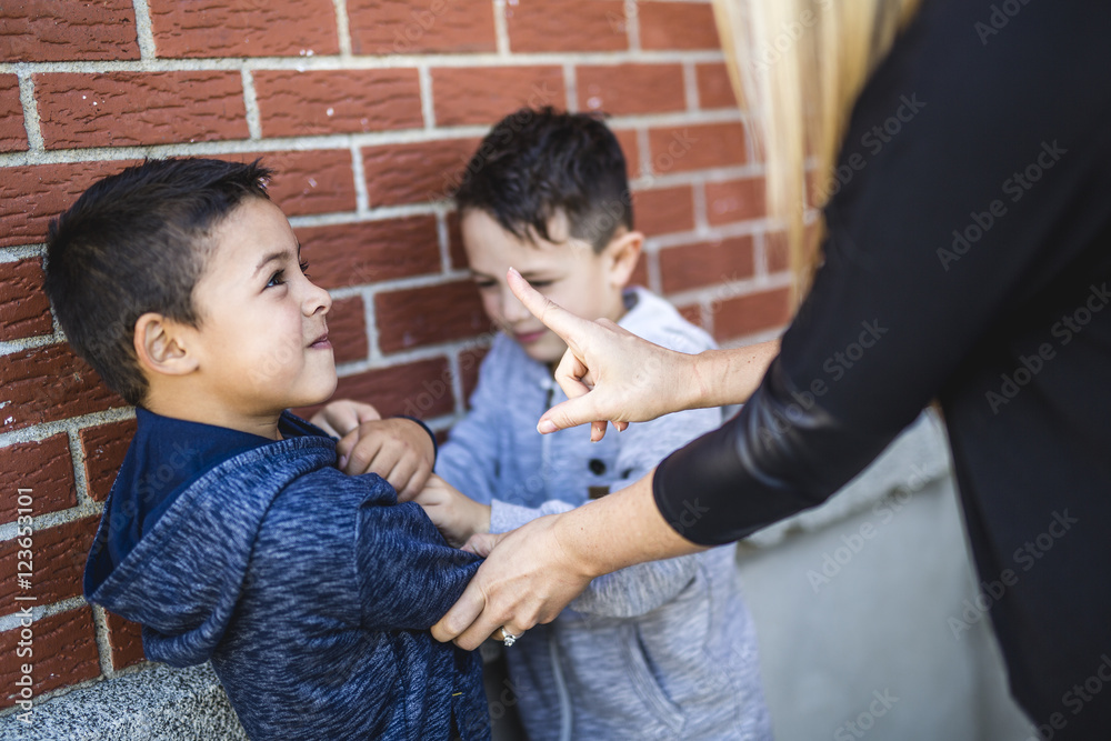 Teacher Stopping Two Boys Fighting In Playground Stock Photo | Adobe Stock