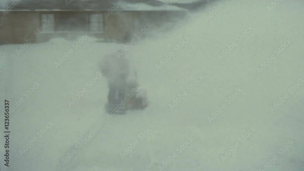 clearing snow after a blizzard with snowblower Stock Video | Adobe Stock