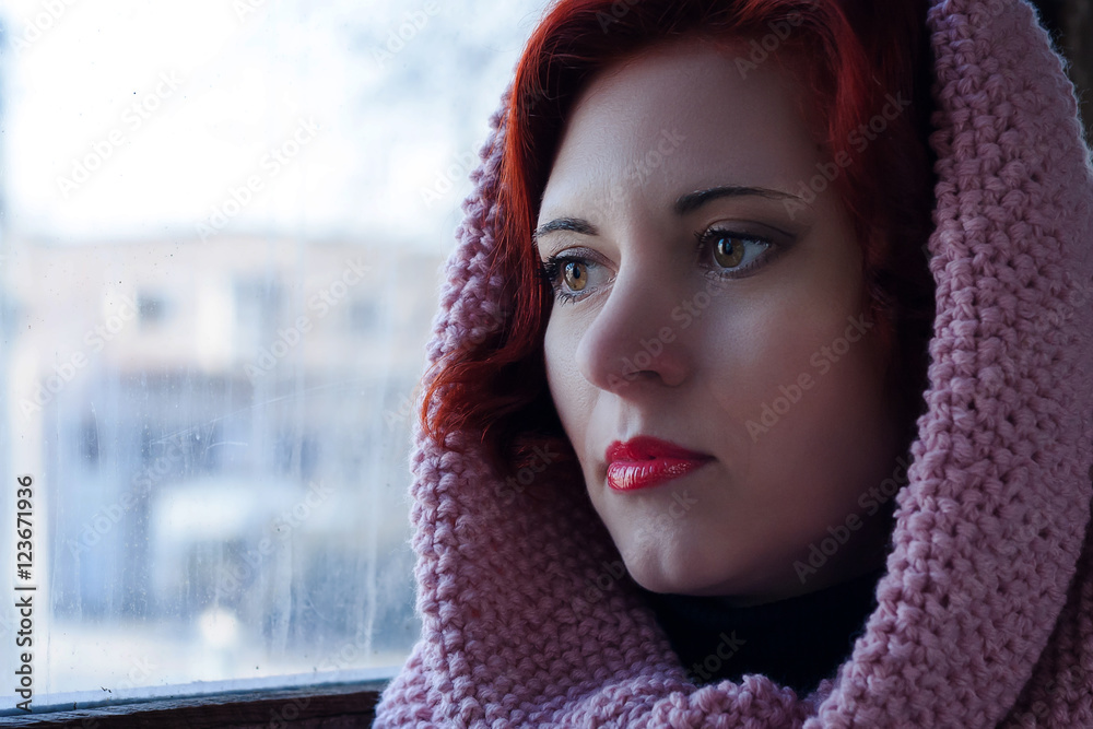 Sad young red-haired girl, a sad girl look with a scarf. Dramatic photo ...