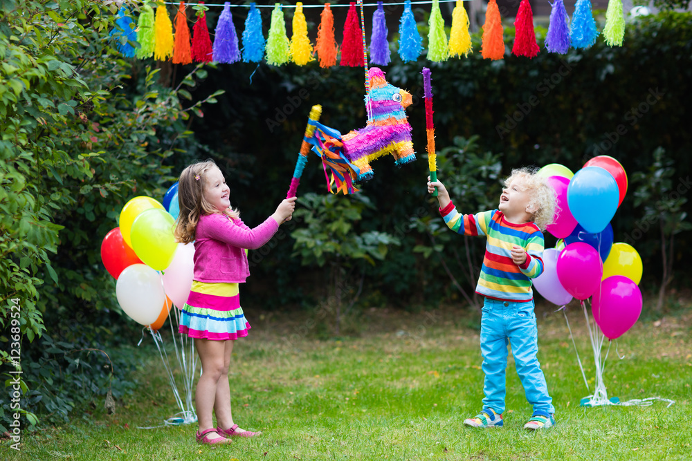 Kids playing with birthday pinata Stock Photo | Adobe Stock