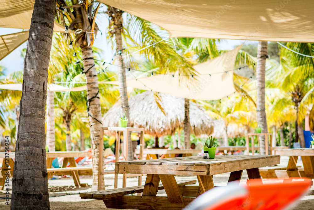Caribbean restaurant at the beach with palm trees Stock Photo | Adobe Stock