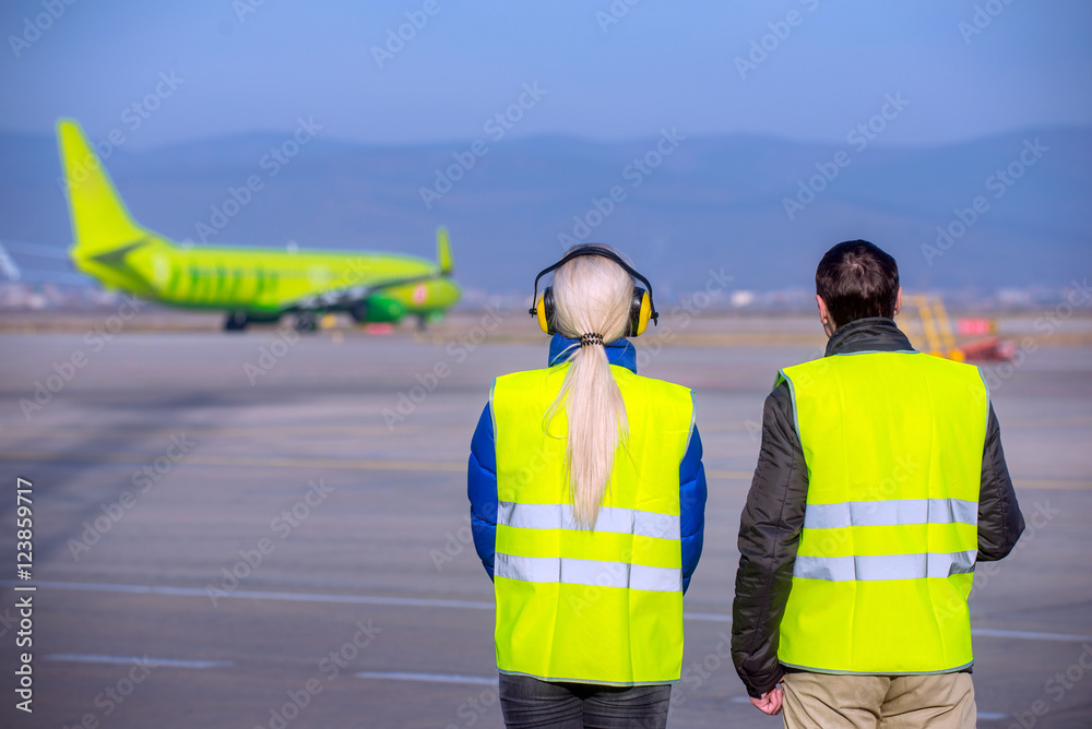 airport staff looking at aircraft Stock Photo | Adobe Stock