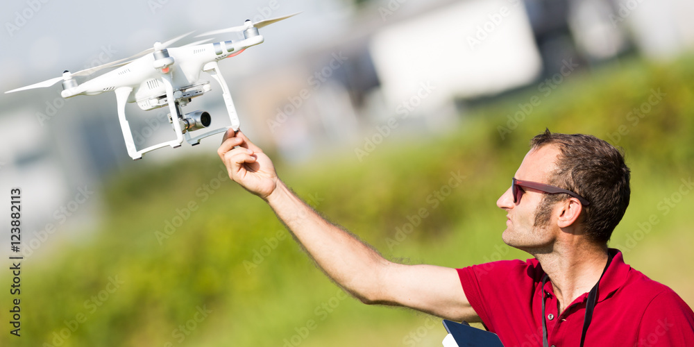 Pilot with his flying drone Stock-Foto | Adobe Stock