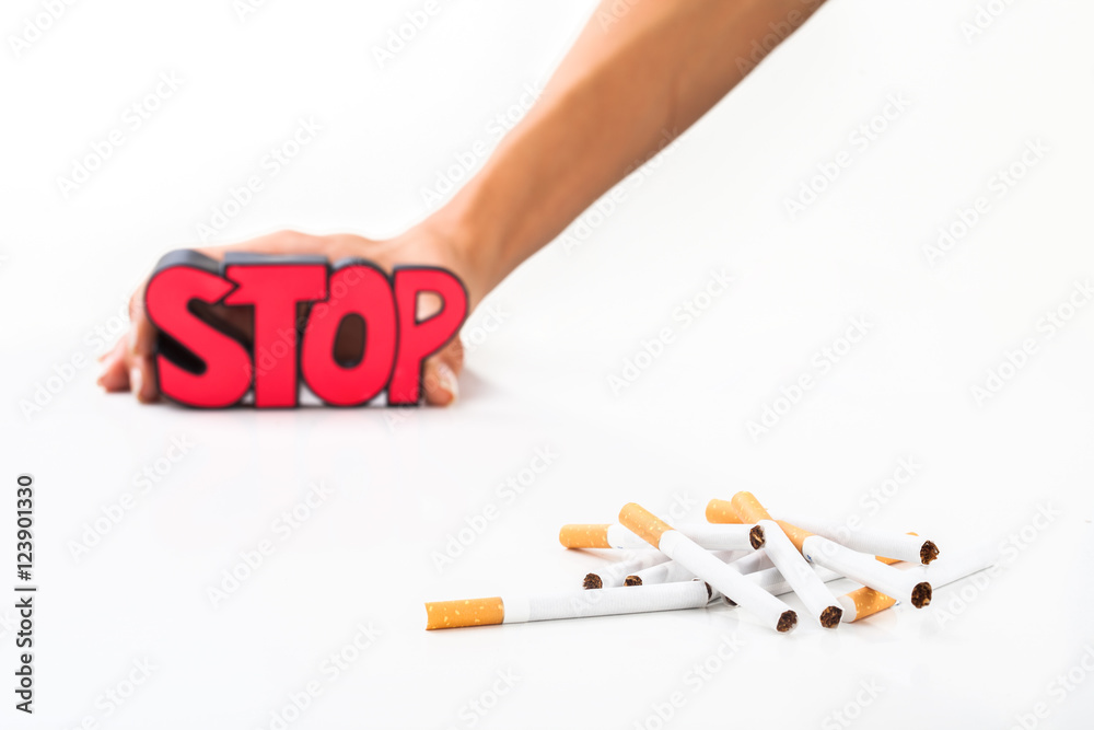 Stop smoking concept, bunch of cigarettes on white background with sign ...