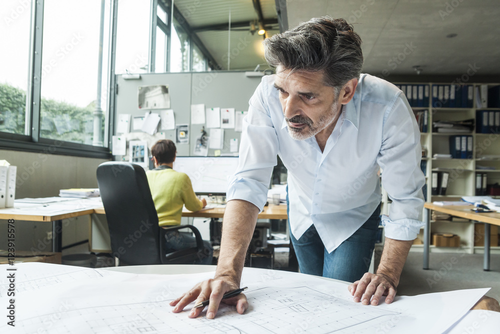 Architect working on ground plan in office Stock Photo | Adobe Stock