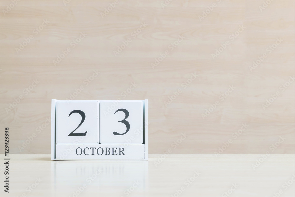 Closeup surface white wooden calendar with black 23 october word on ...