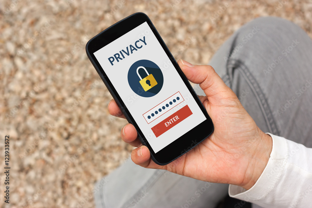 Hand holding smart phone with online privacy concept on screen. All ...