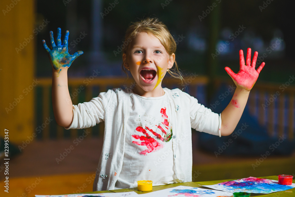 Child having fun painting with finger paint Stock Photo | Adobe Stock