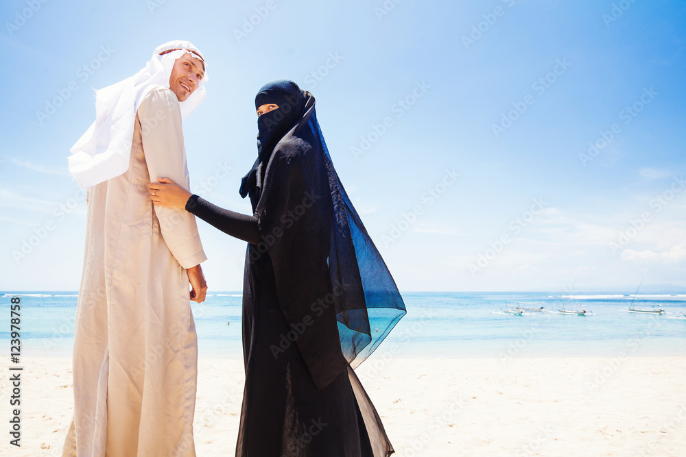 muslim couple on a beach wearing traditional dress Stock Photo | Adobe ...